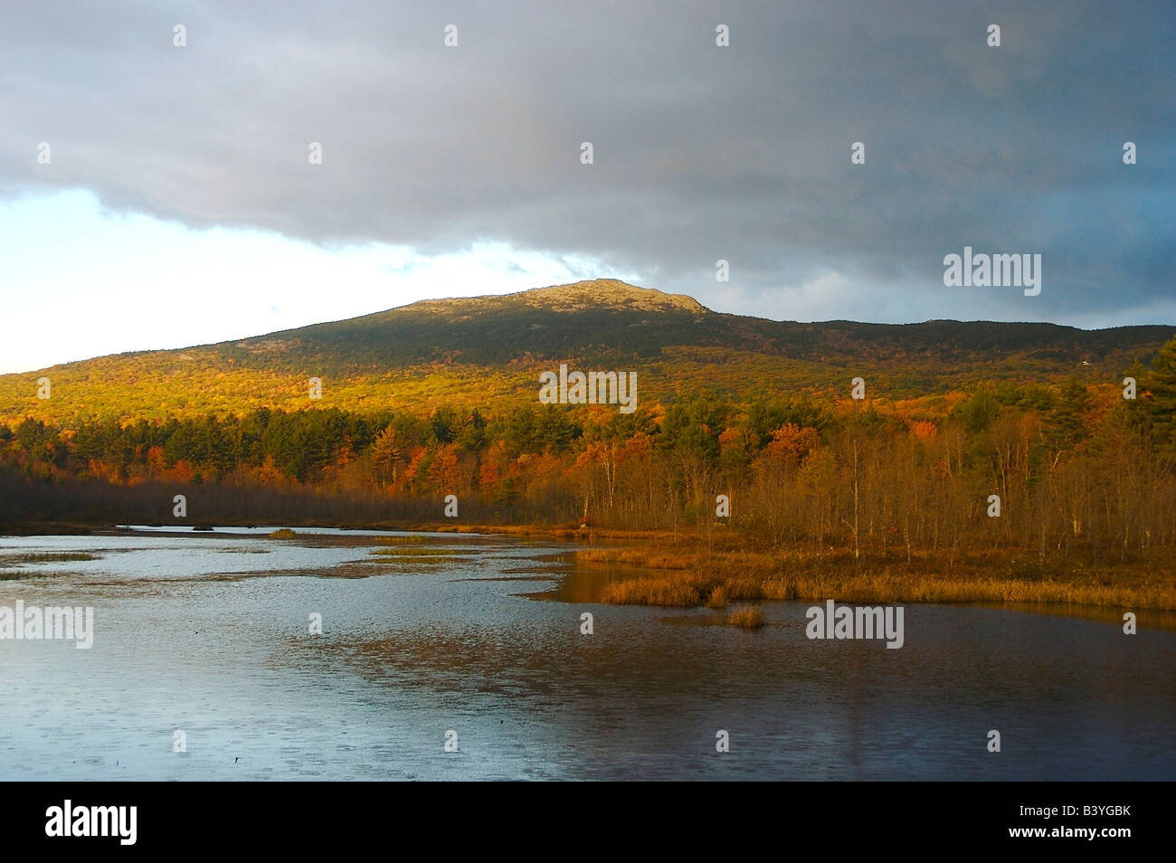 North America, USA, New Hampshire, Keene. An autumn view across a pond ...