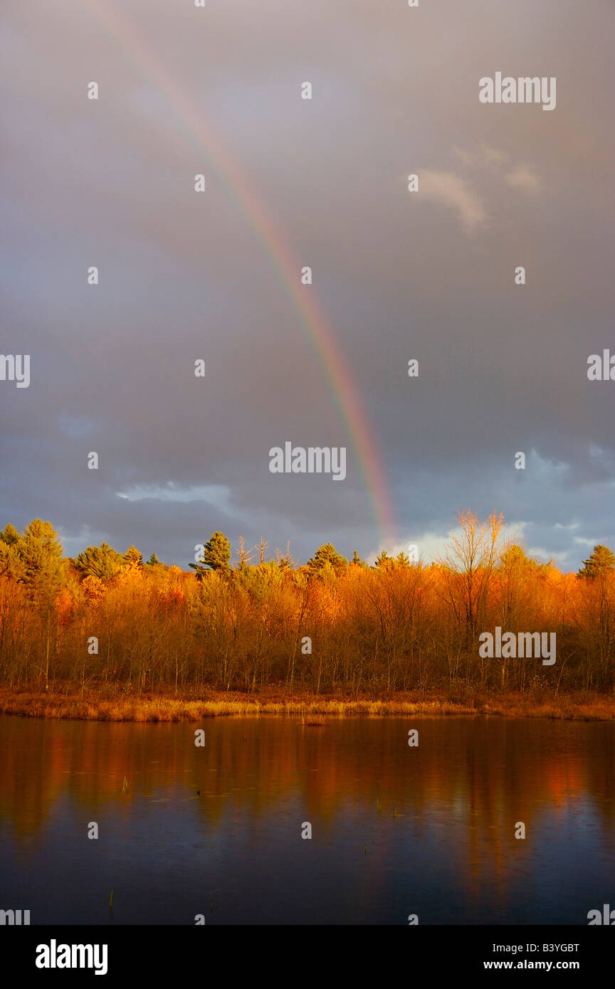 North America, USA, New Hampshire, Keene. A rainbow over a pond near ...