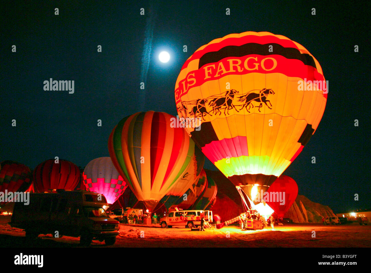 USA, New Mexico, Gallup. Inflated hot-air balloons at night against ...
