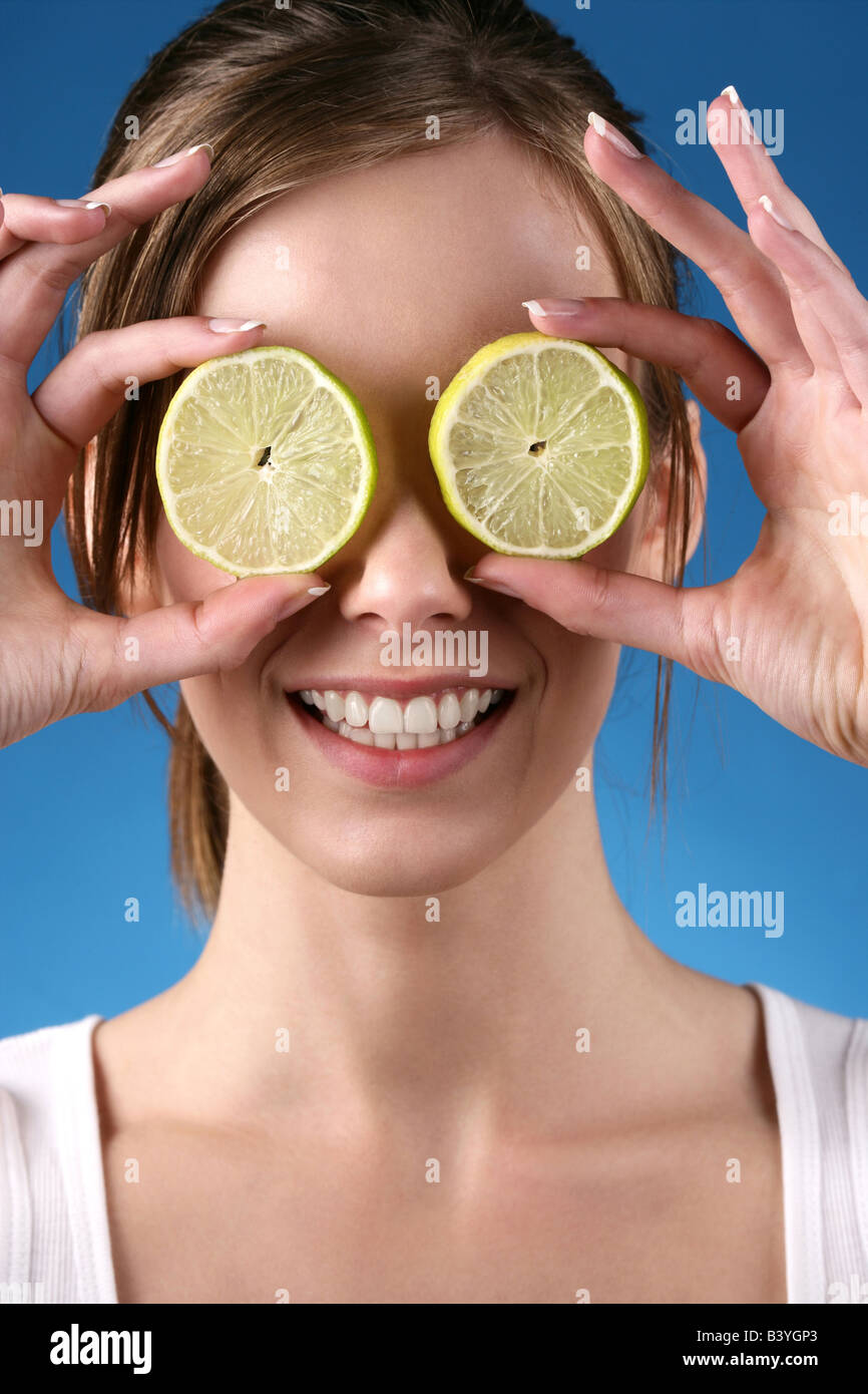 Female model holding lemon slices Stock Photo - Alamy