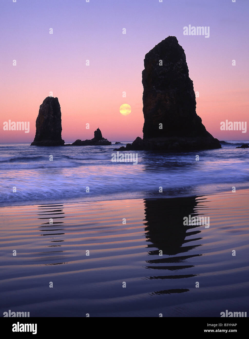 USA, Oregon, Cannon Beach.The Needles rock monoliths at sunrise showing ...