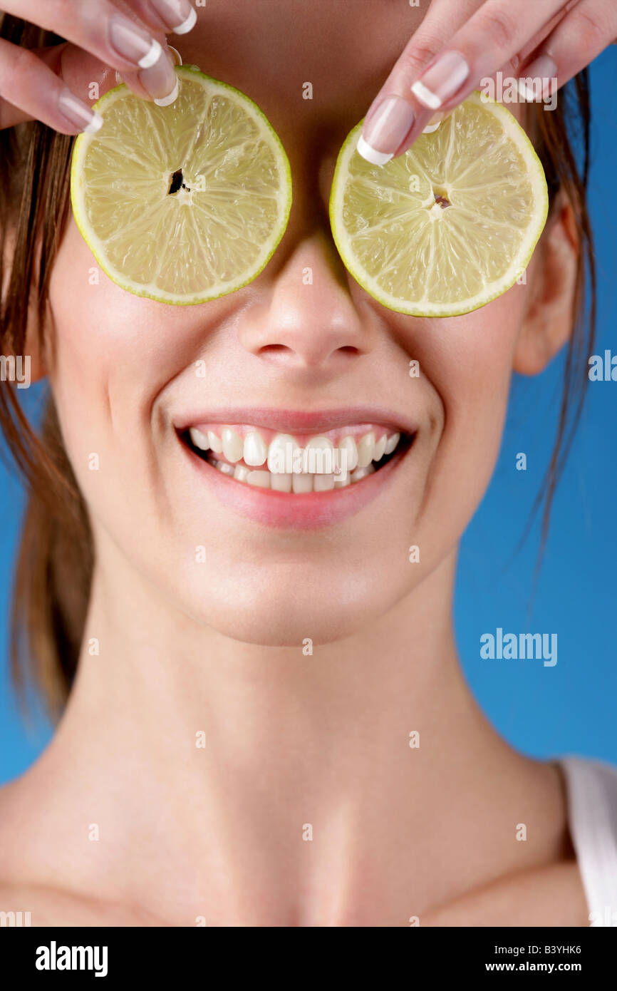 Female model holding lemon slices Stock Photo - Alamy