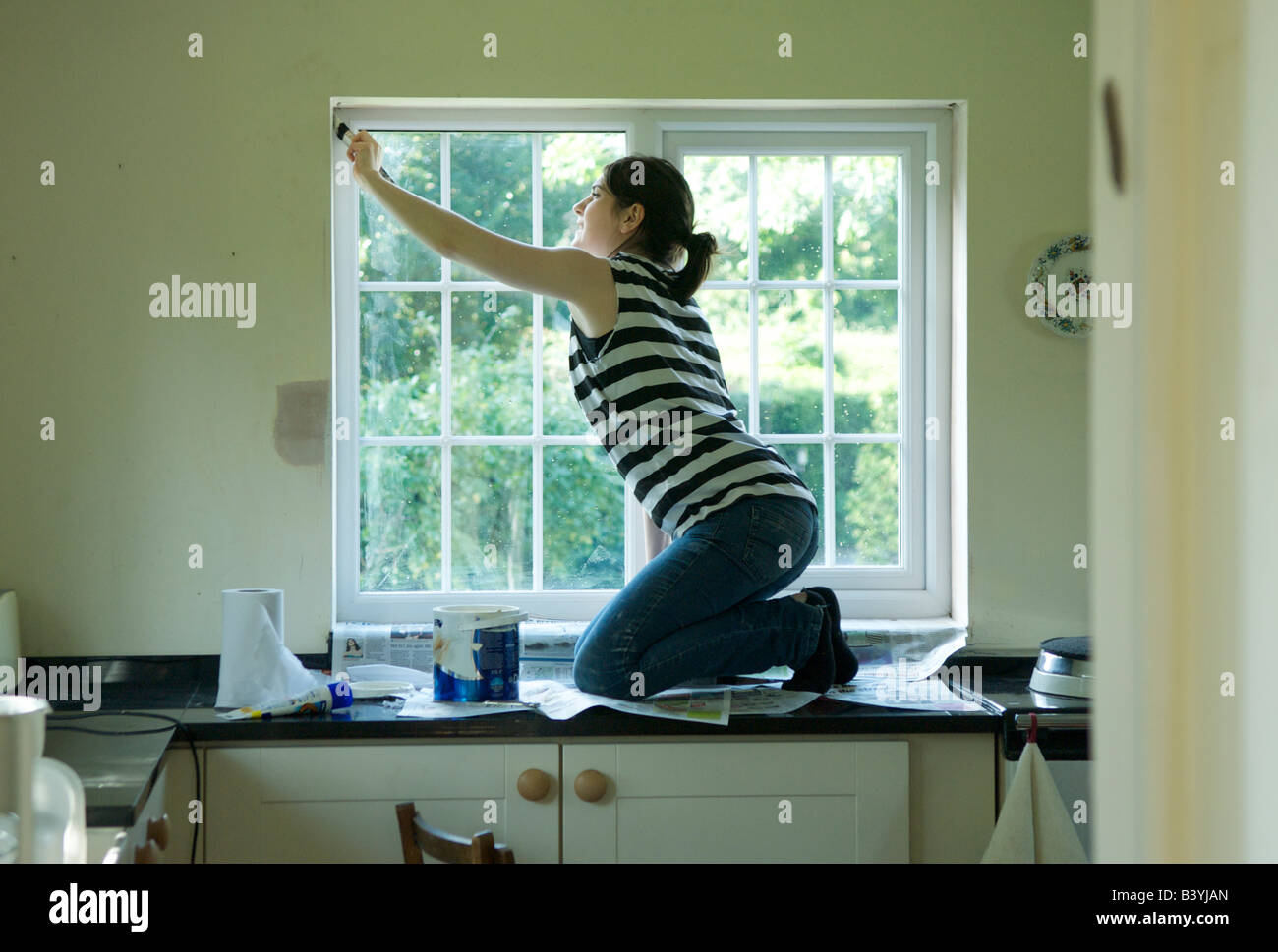 young woman decorating new home Stock Photo - Alamy