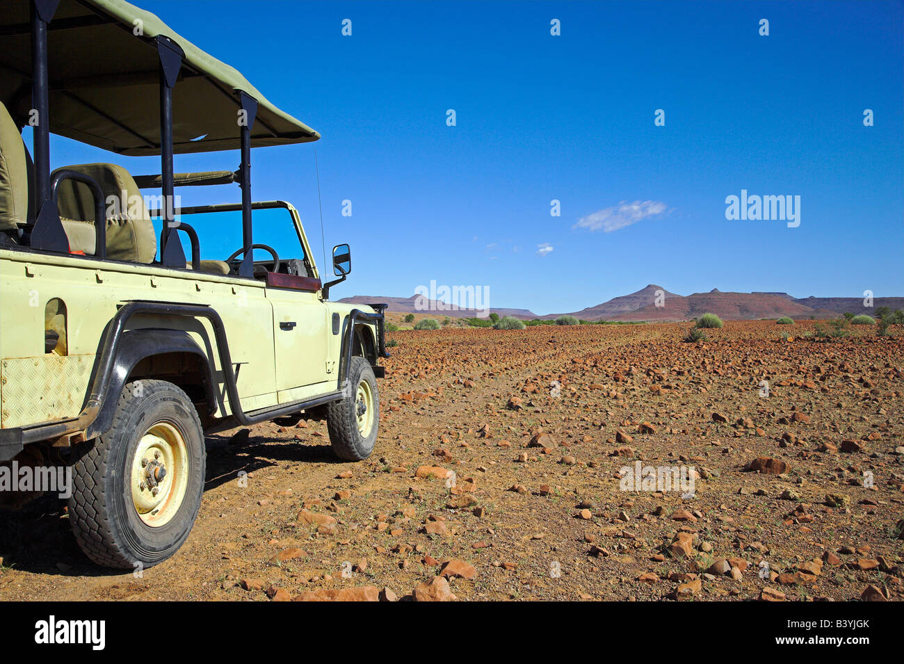 An open sided Land Rover on an offroad trail while tracking Black Rhino ...