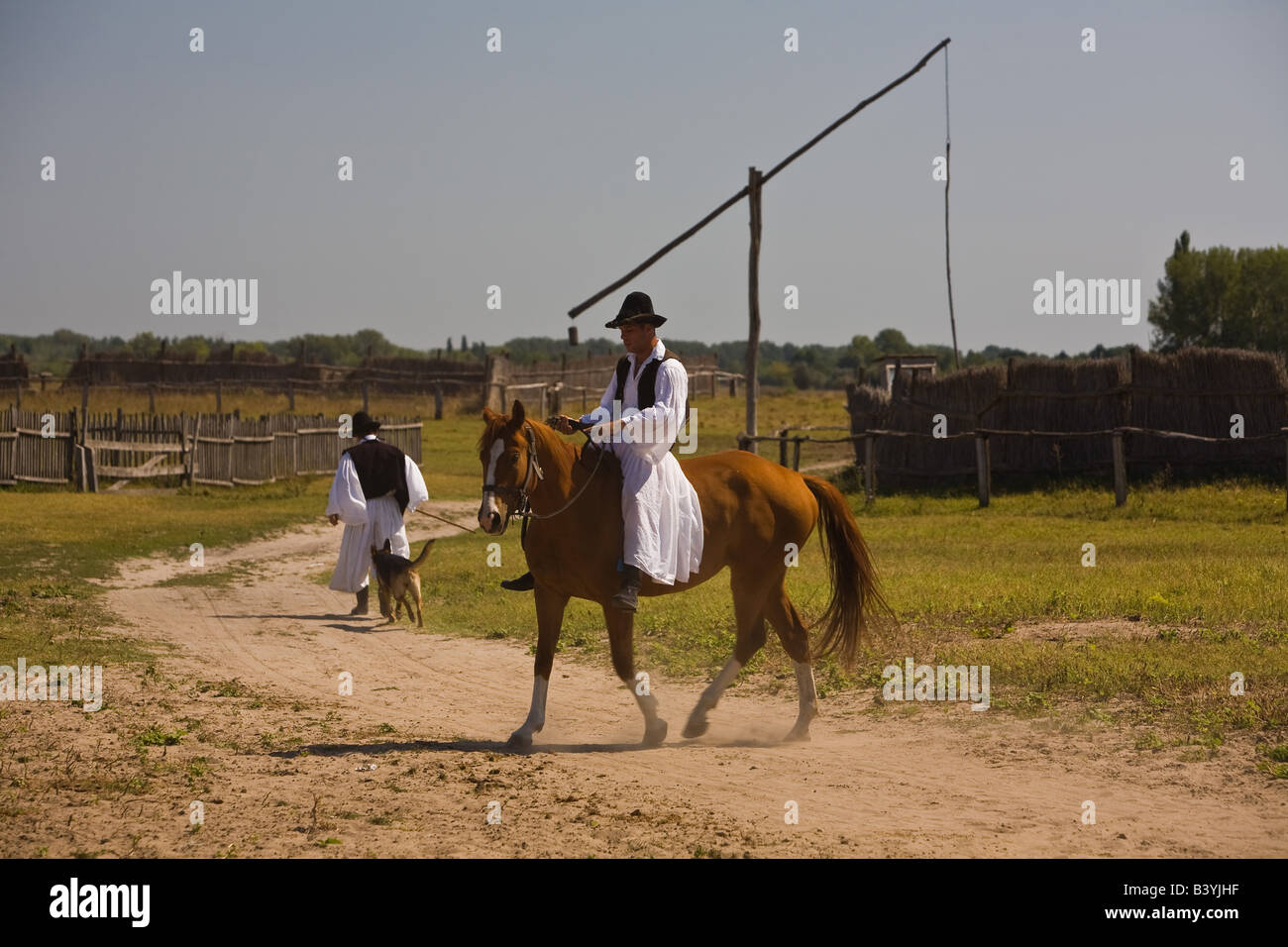 Two shepherds in front of a draw well in the Puszta Stock Photo - Alamy