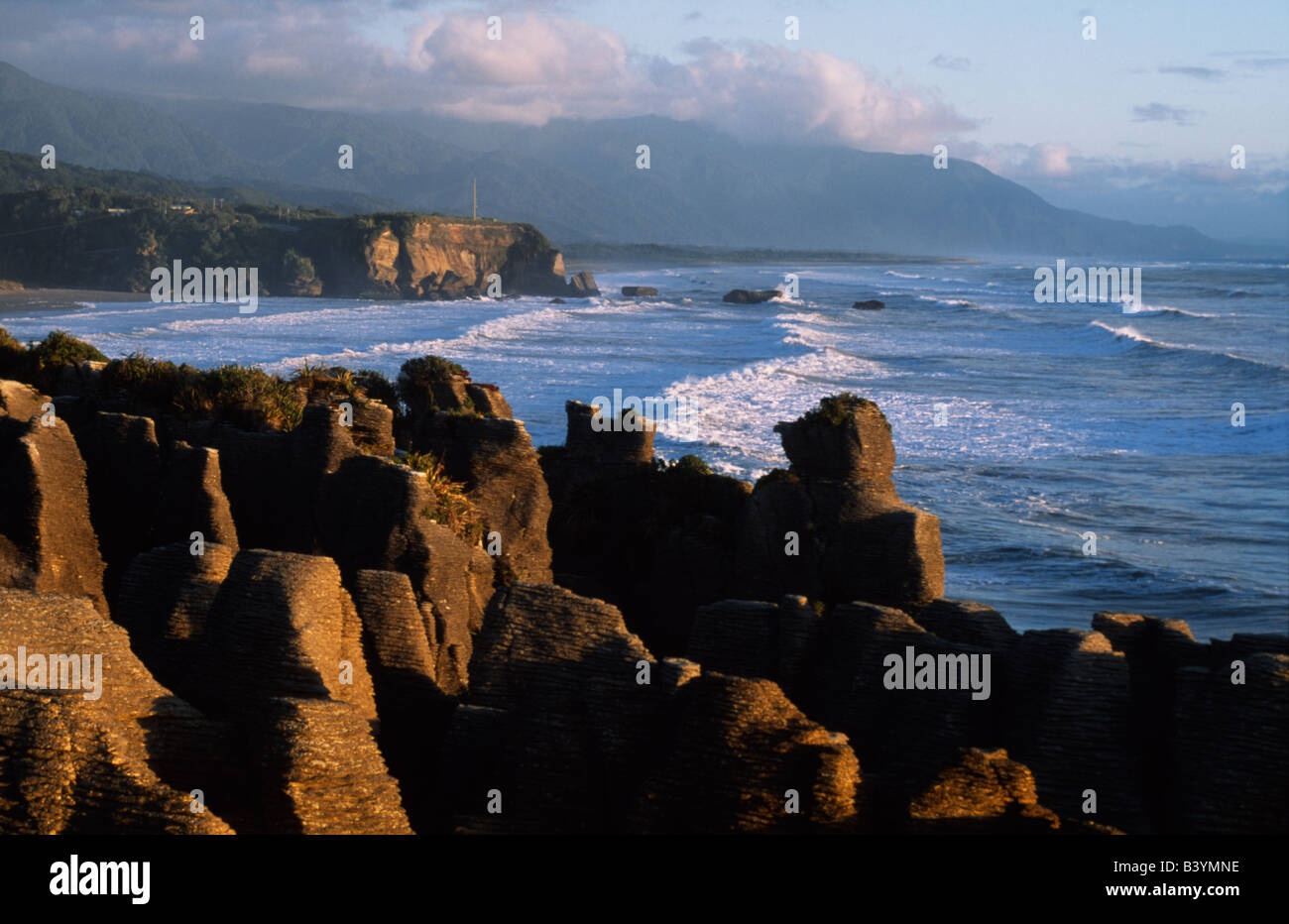 Sunset on Pancake Rocks at Punakaiki with surf and beach in the ...