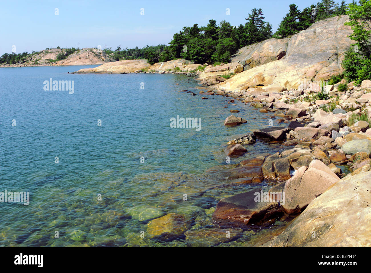 Clean blue water at the beach of a small island in Georgian Bay Stock ...