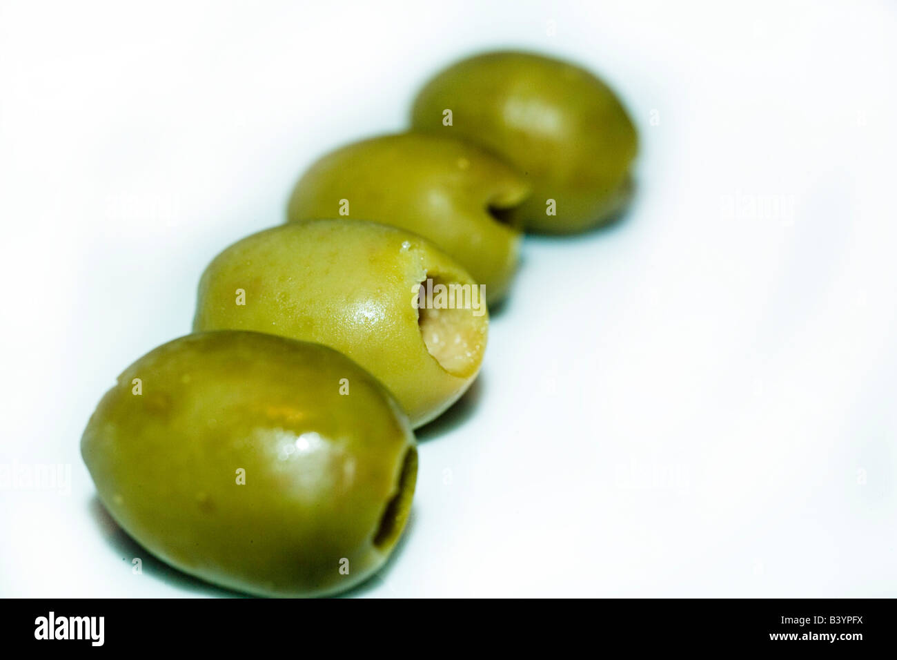 four green olives Stock Photo - Alamy