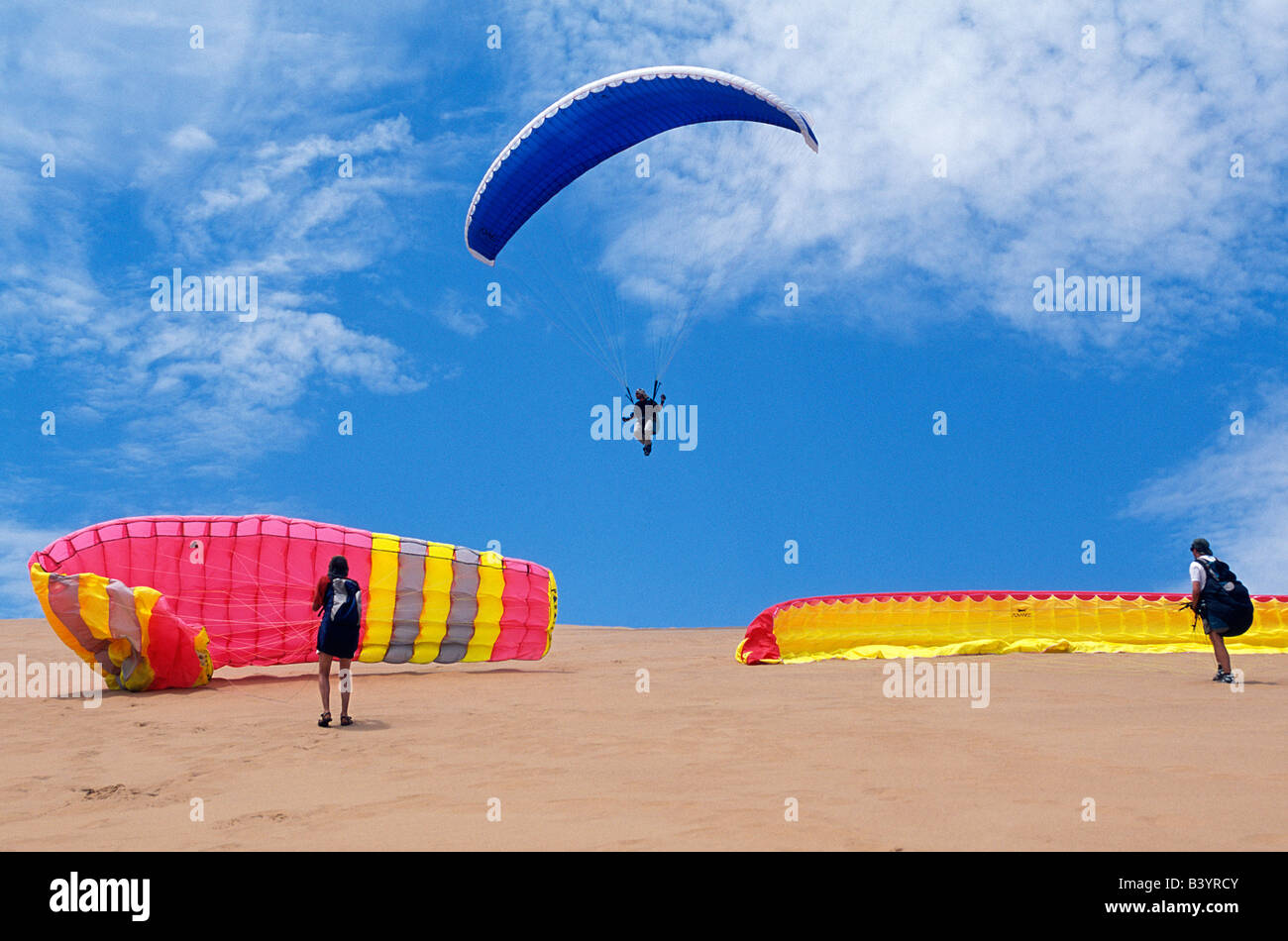 Namibia, Skeleton Coast. Paragliding over the dunes of the Namib Desert ...