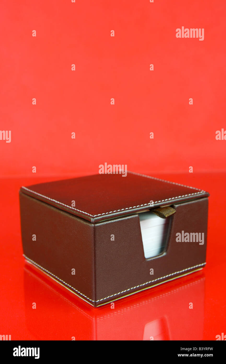A note block isolated against a red background Stock Photo - Alamy