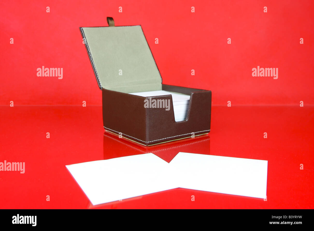 A note block isolated against a red background Stock Photo - Alamy