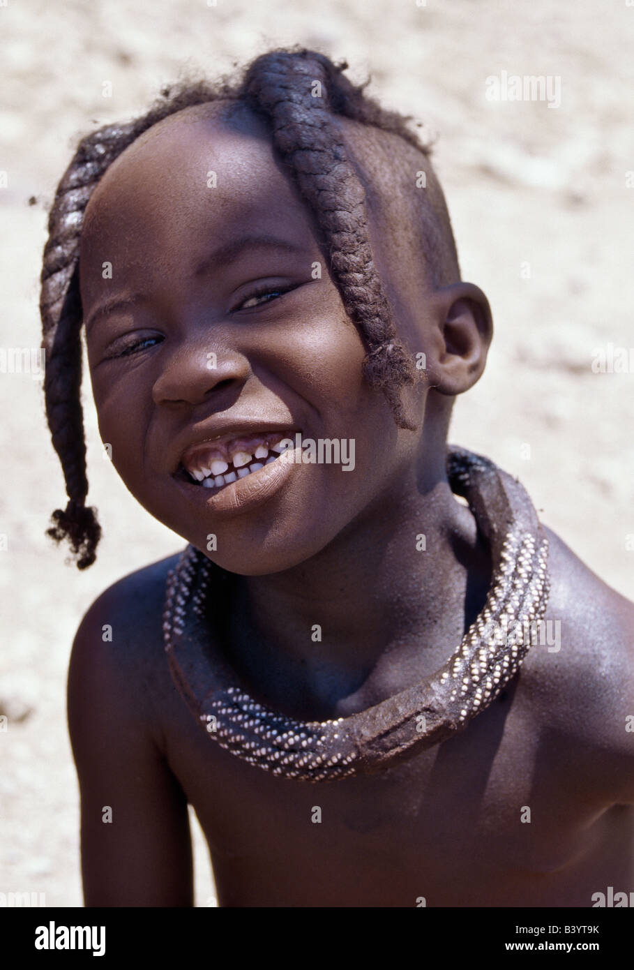 Namibia, Damaraland, Palmwag. A Himba girl with a plaited hairstyle ...