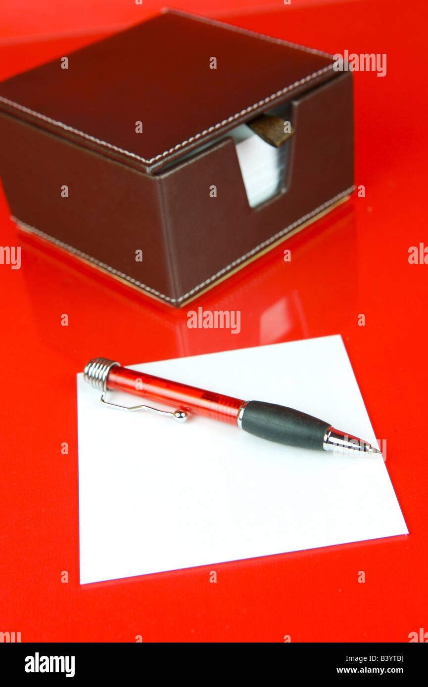 A note block isolated against a red background Stock Photo - Alamy