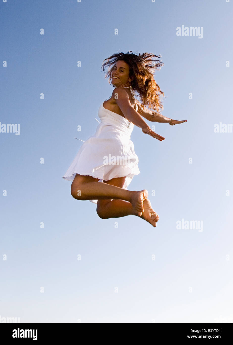 Girl jumping free air Stock Photo - Alamy