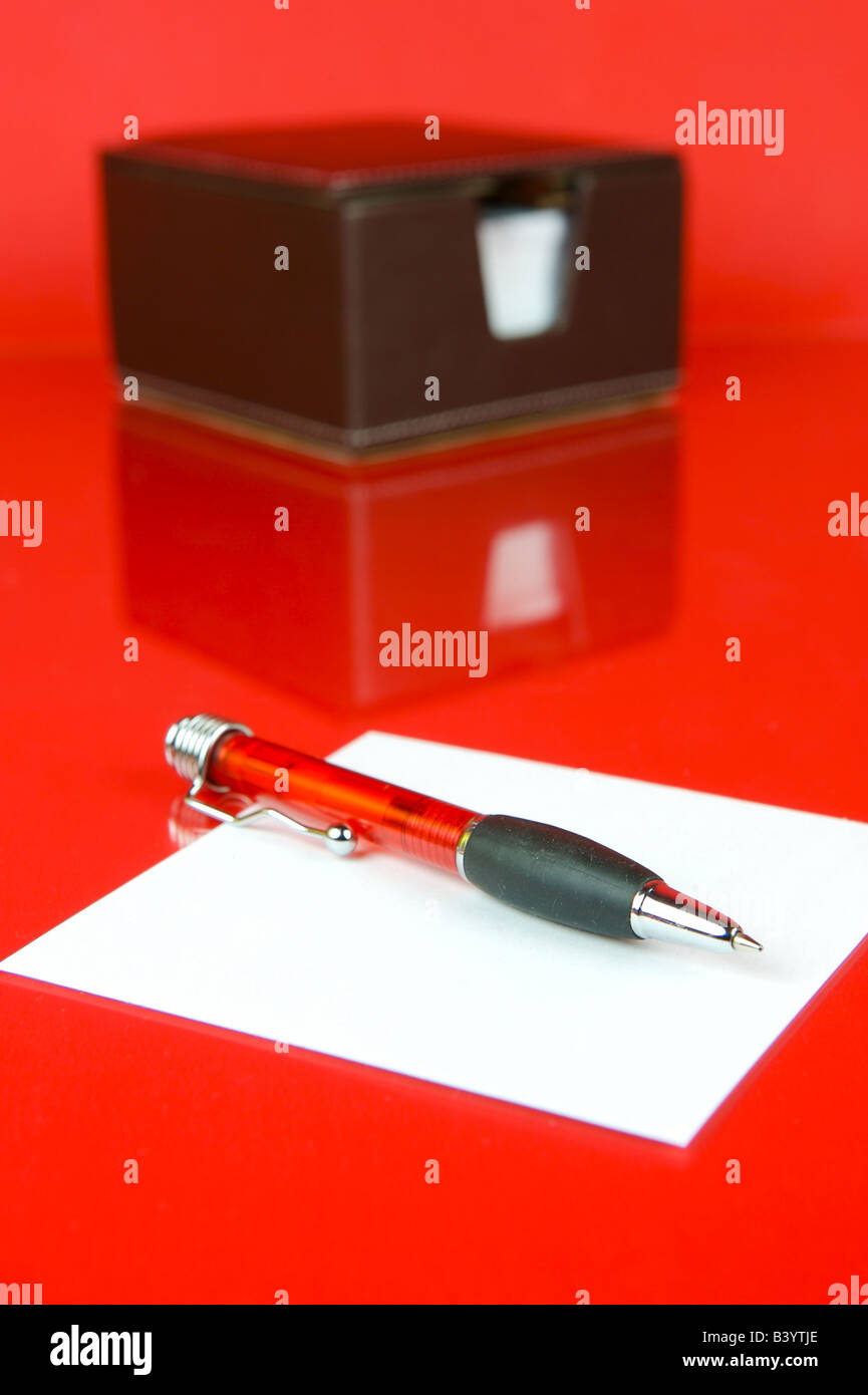A note block isolated against a red background Stock Photo - Alamy