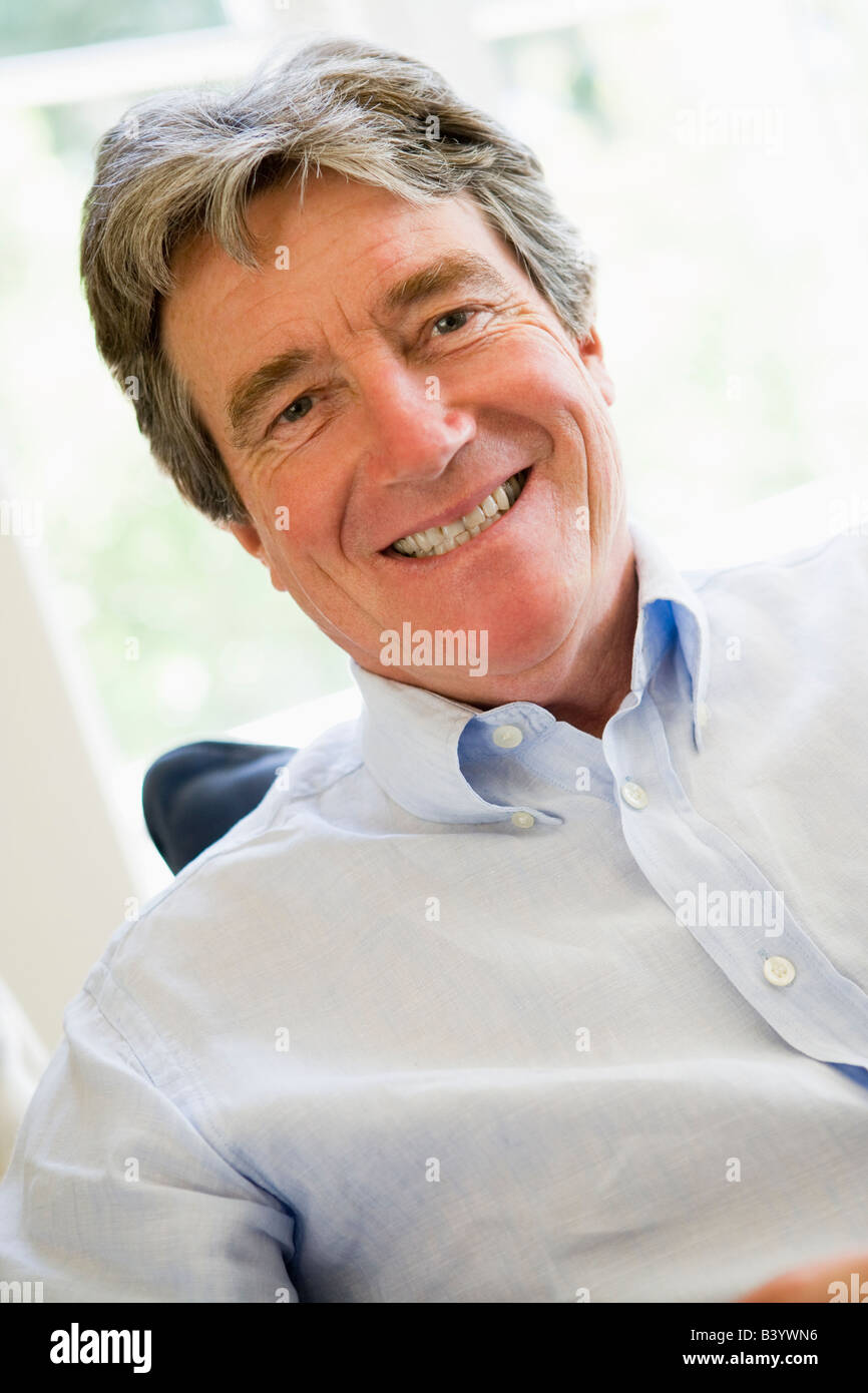 Man in living room smiling Stock Photo - Alamy