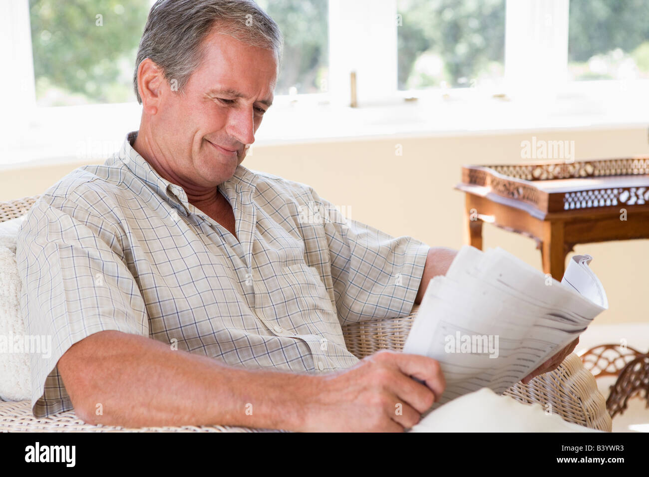Man reading newspaper in lounge hi-res stock photography and images - Alamy