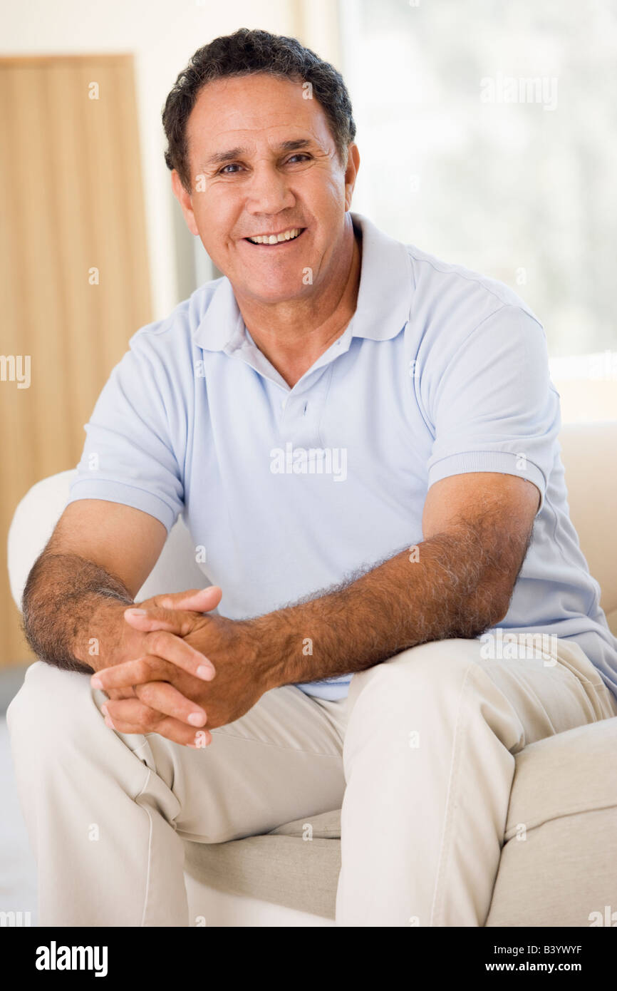 Man in living room smiling Stock Photo - Alamy