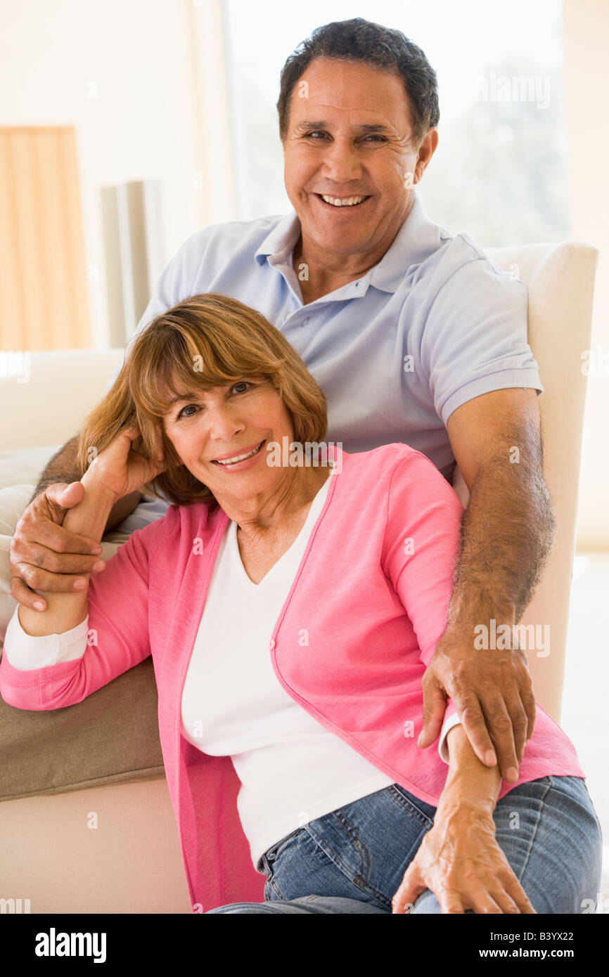 Couple in living room smiling Stock Photo - Alamy