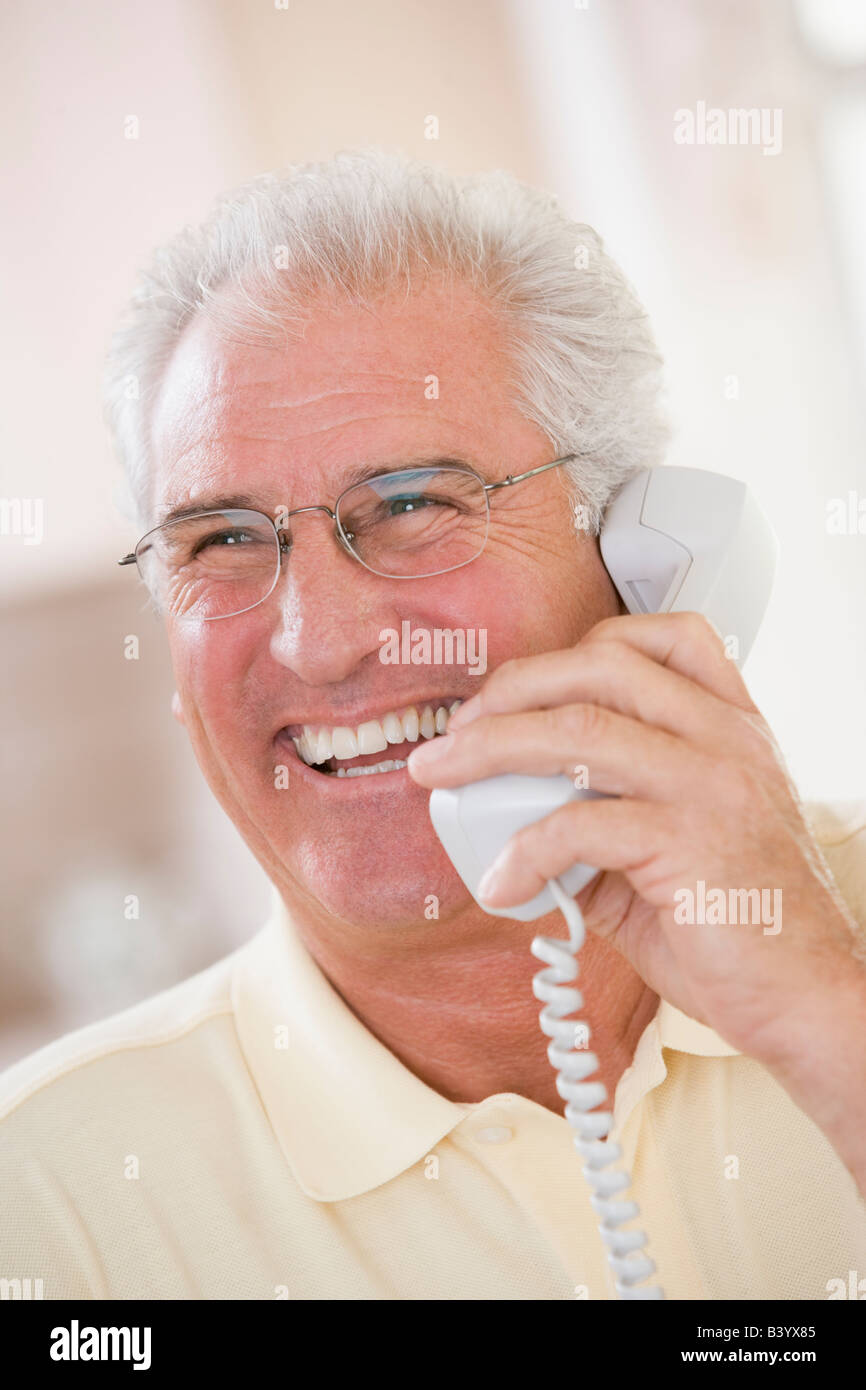 Man using telephone and smiling Stock Photo - Alamy