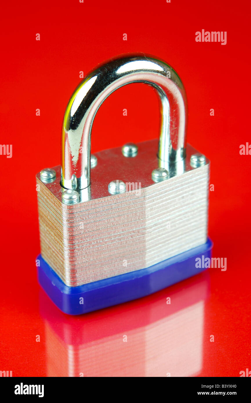 A padlock isolated against a red background Stock Photo - Alamy