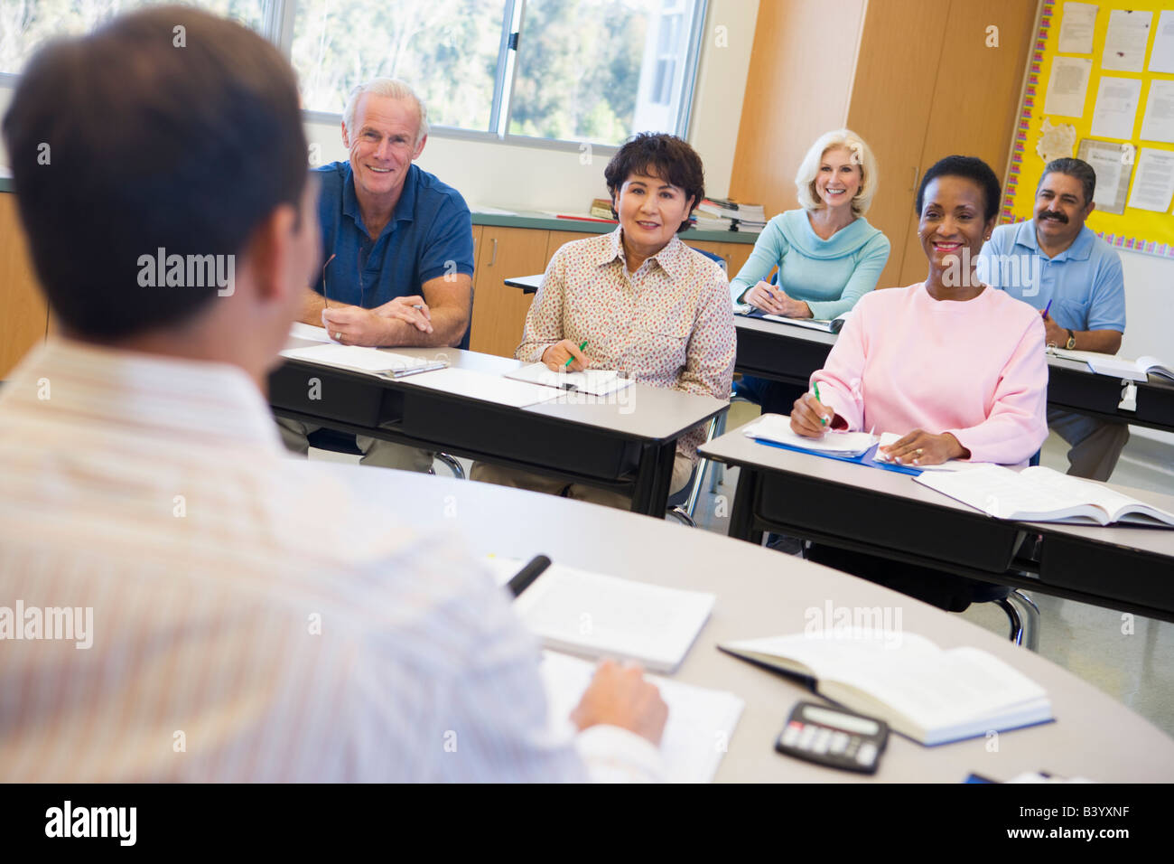 Adult students in class with teacher (selective focus Stock Photo - Alamy