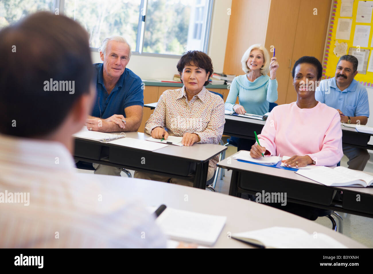 Adult students in class with teacher (selective focus Stock Photo - Alamy
