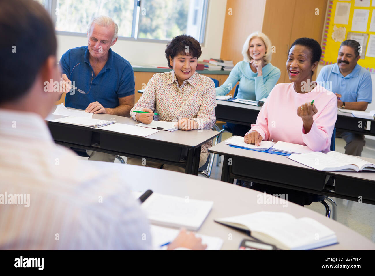 Adult students in class with teacher (selective focus Stock Photo - Alamy