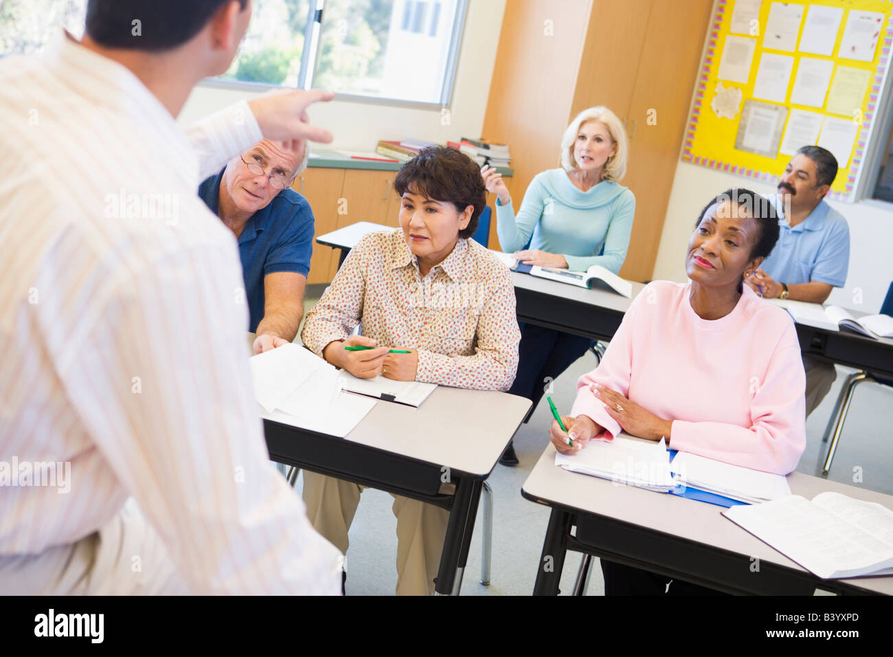 Adult students in class with teacher (selective focus Stock Photo - Alamy