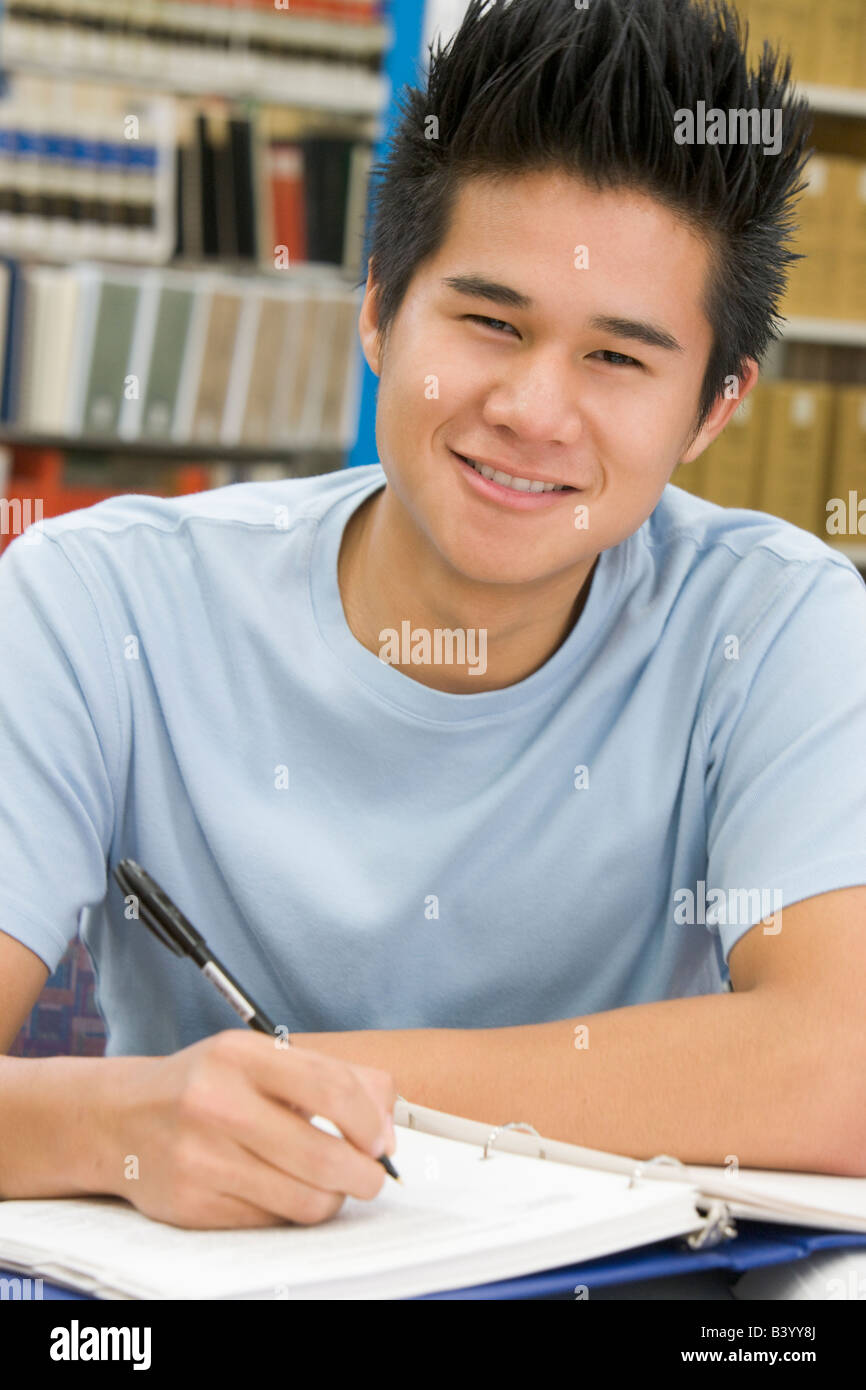 Man sitting in library studying Stock Photo - Alamy