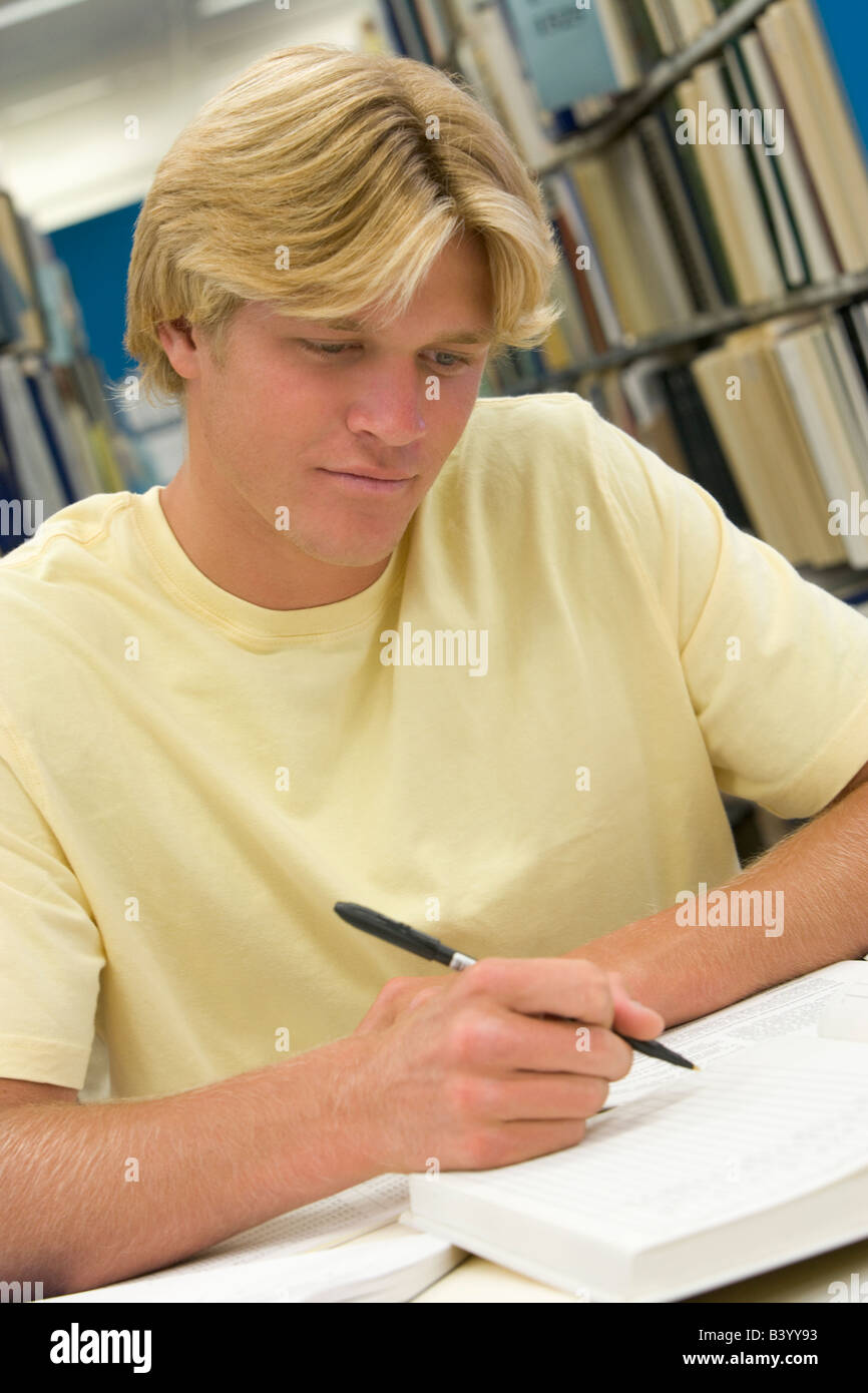 Man sitting in library studying Stock Photo - Alamy