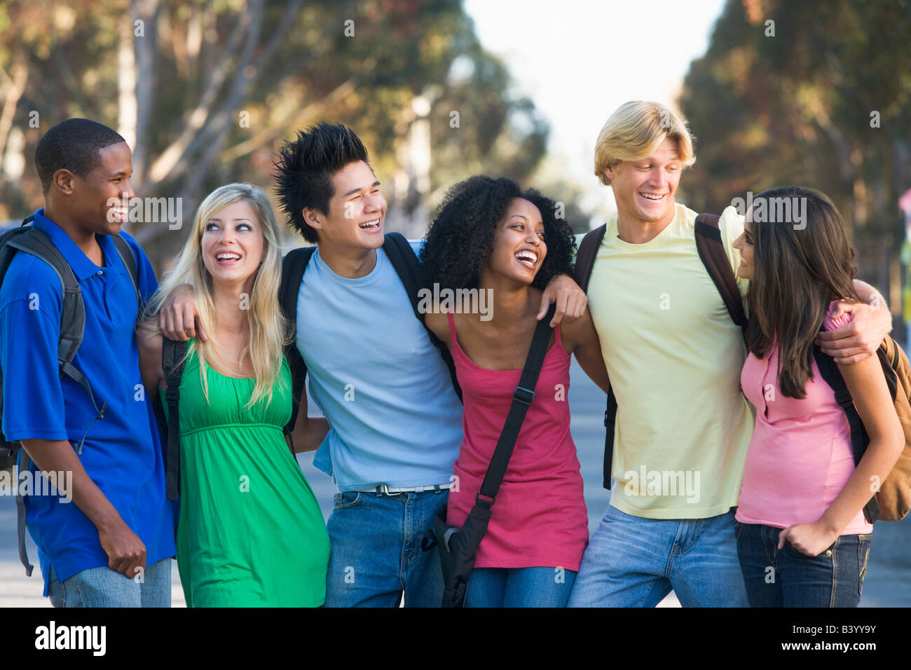 Six people outdoors standing arm in arm together (selective focus Stock ...