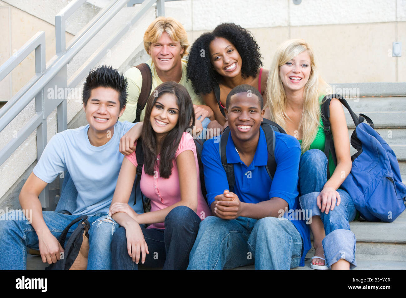 Six people sitting on staircase outdoors smiling Stock Photo - Alamy
