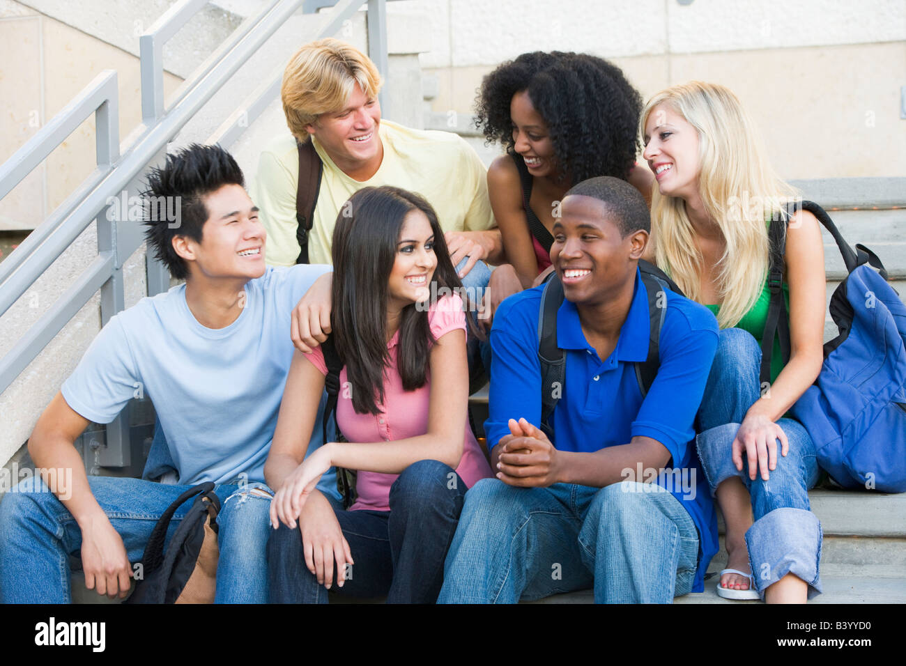 Six people sitting on staircase outdoors smiling Stock Photo - Alamy