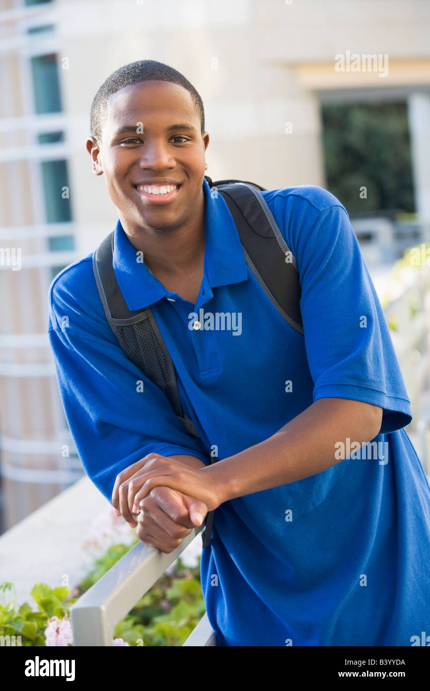 Man standing on balcony leaning on railing (selective focus Stock Photo ...