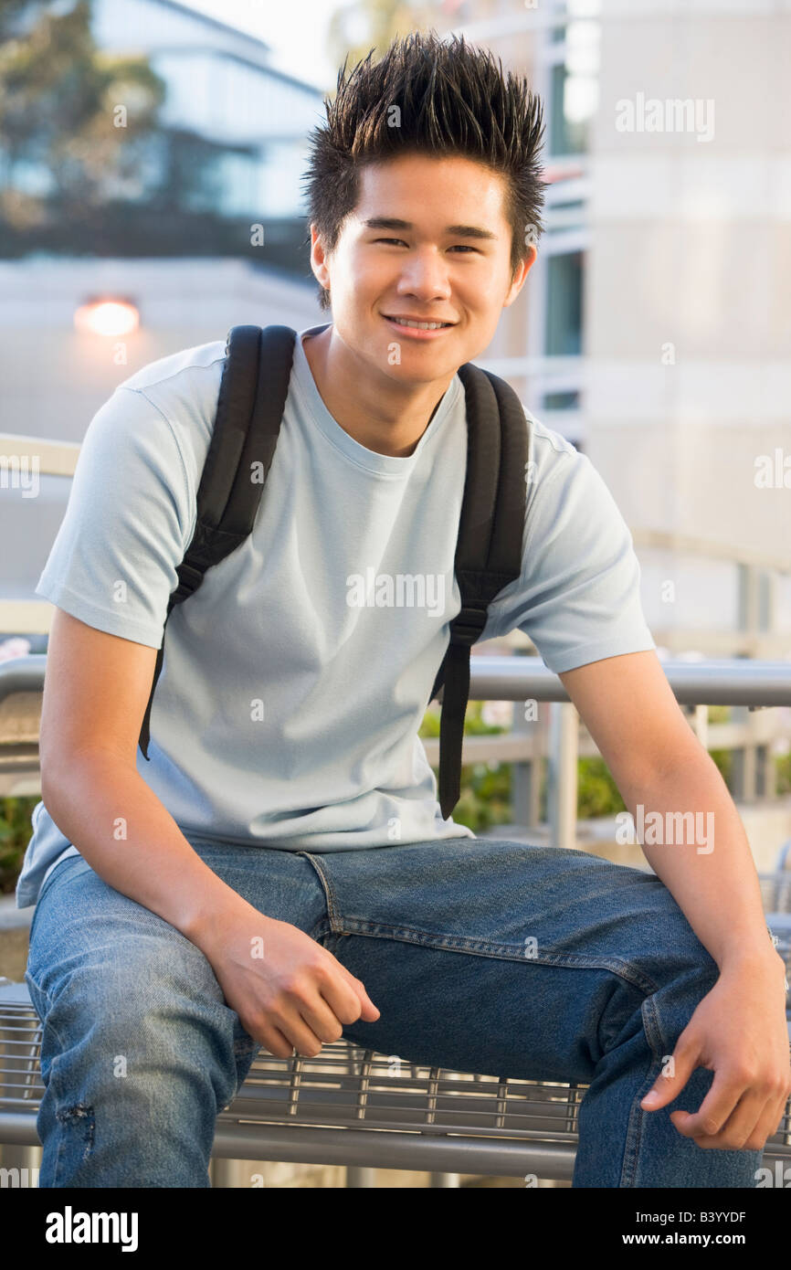 Man sitting on bench outdoors smiling (selective focus Stock Photo - Alamy