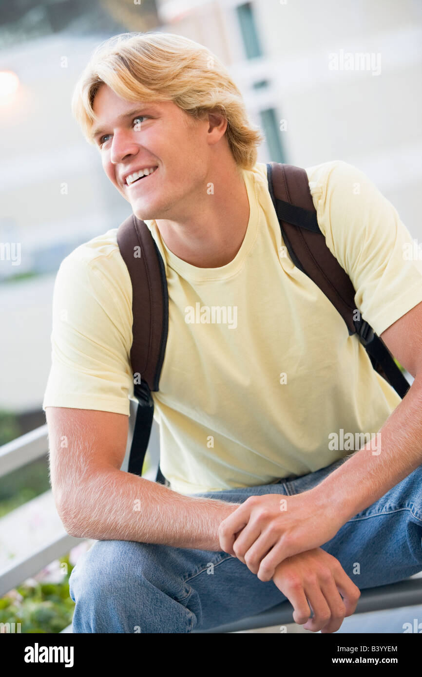Man sitting outdoors on bench smiling (selective focus Stock Photo - Alamy