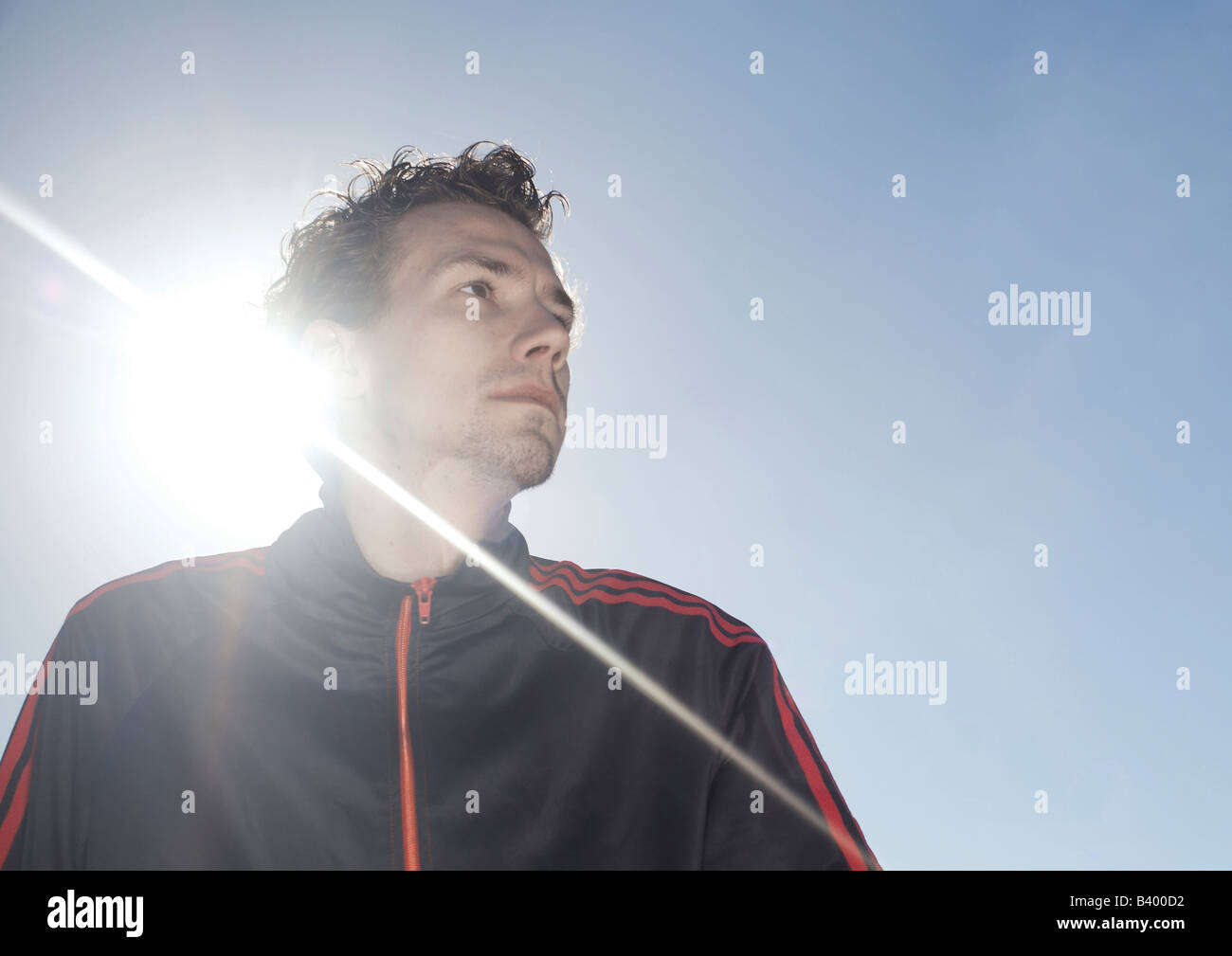 Young man in backlight Stock Photo - Alamy