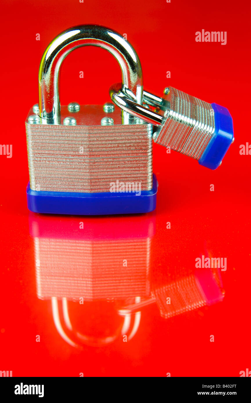 A padlock isolated against a red background Stock Photo - Alamy