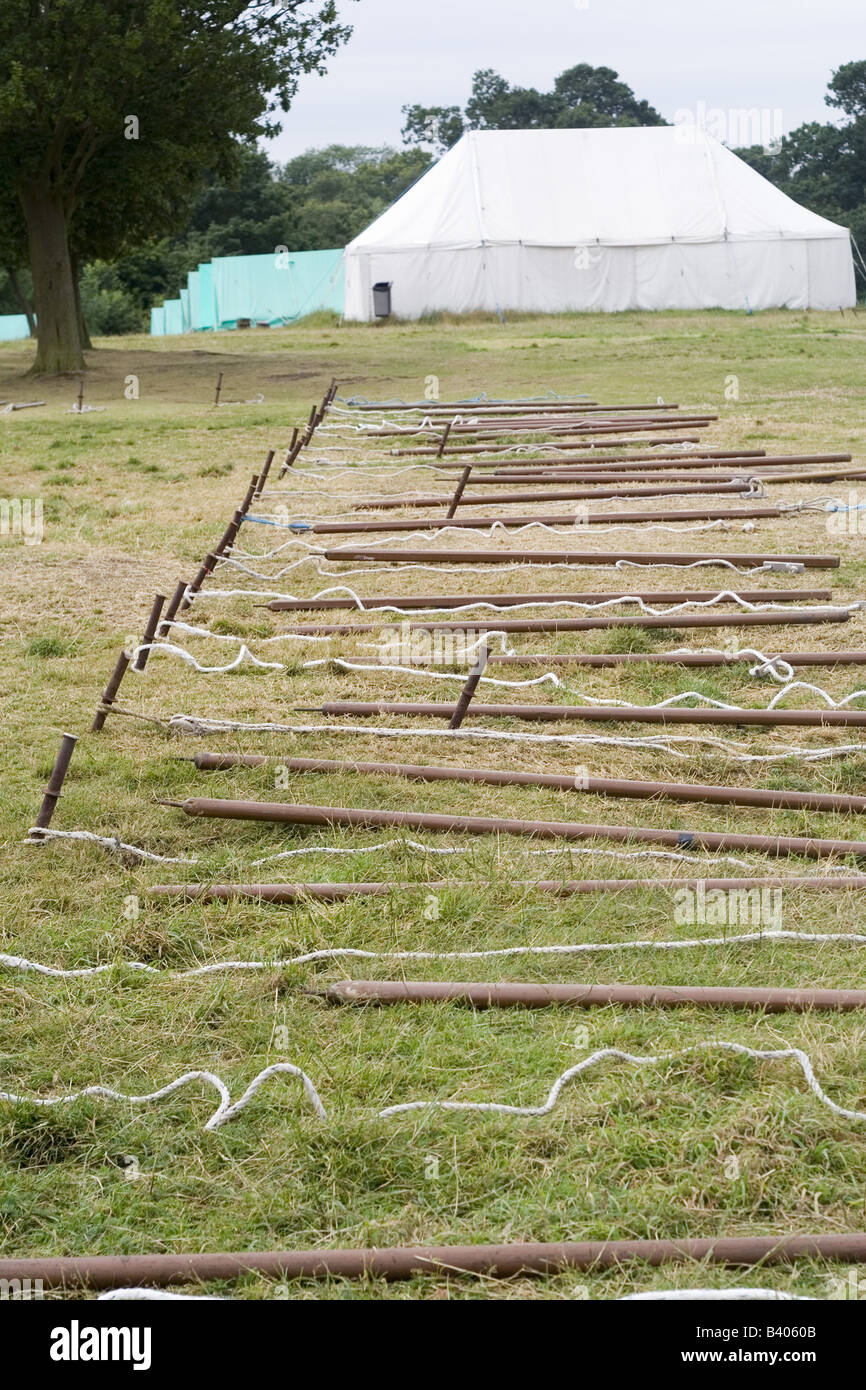 Pegs guy ropes and poles layed out on the ground waiting to be used to ...