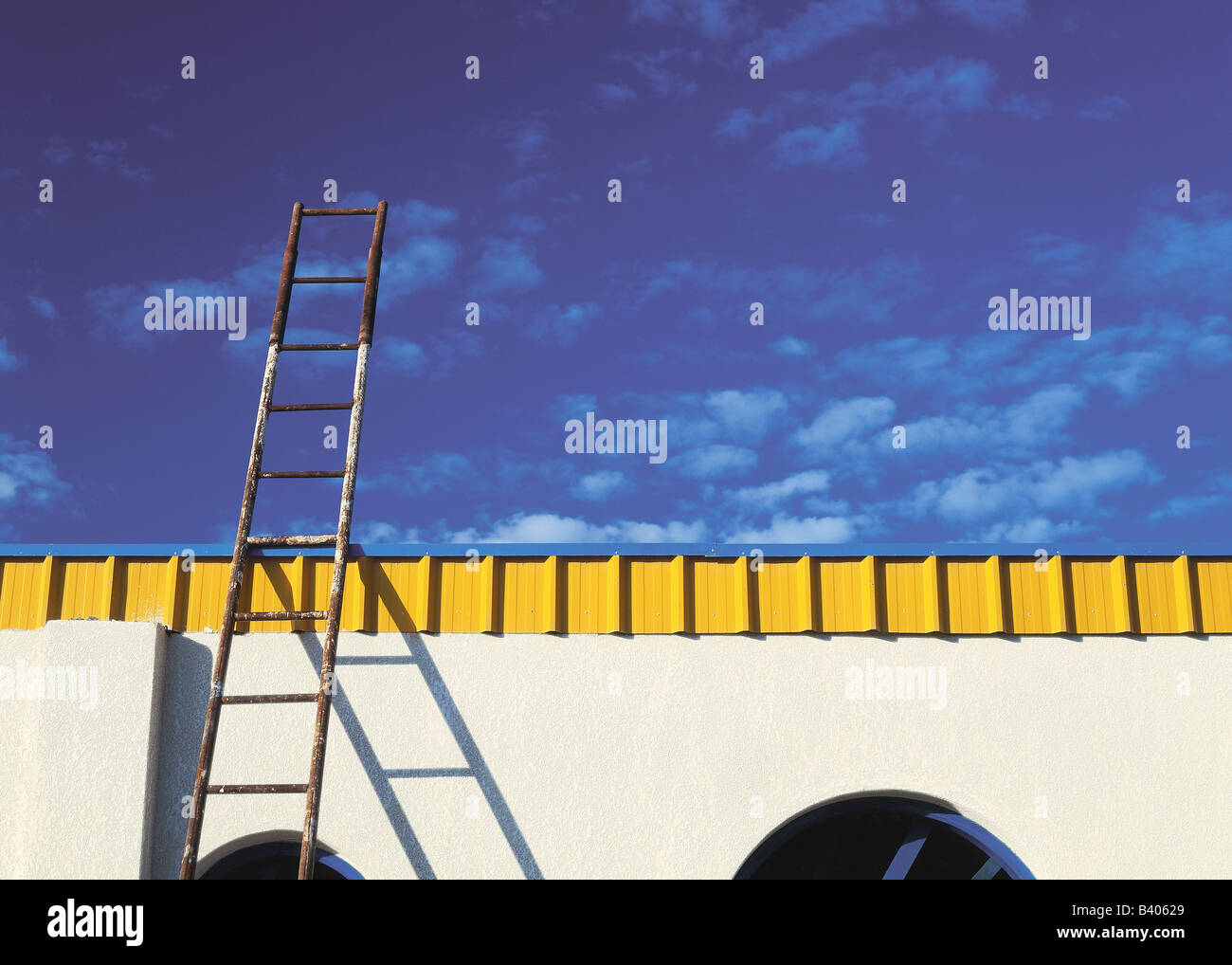 Ladder leaning against a wall Stock Photo - Alamy