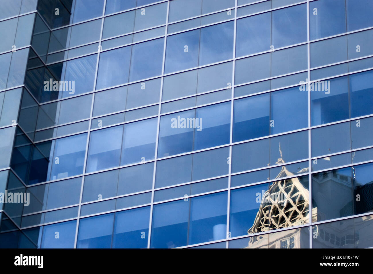 A closeup of a modern office building and another building visible in a ...