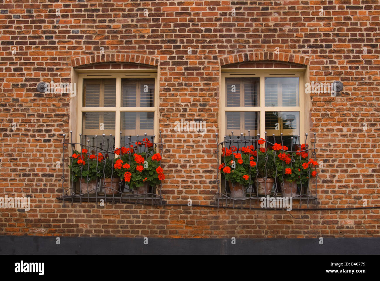 Pretty flowers in pots seated on window sills of charactaristic house ...