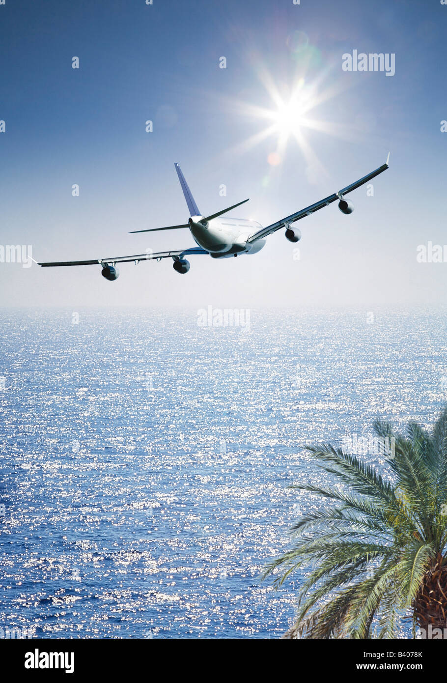 Airplane flying over ocean Stock Photo - Alamy