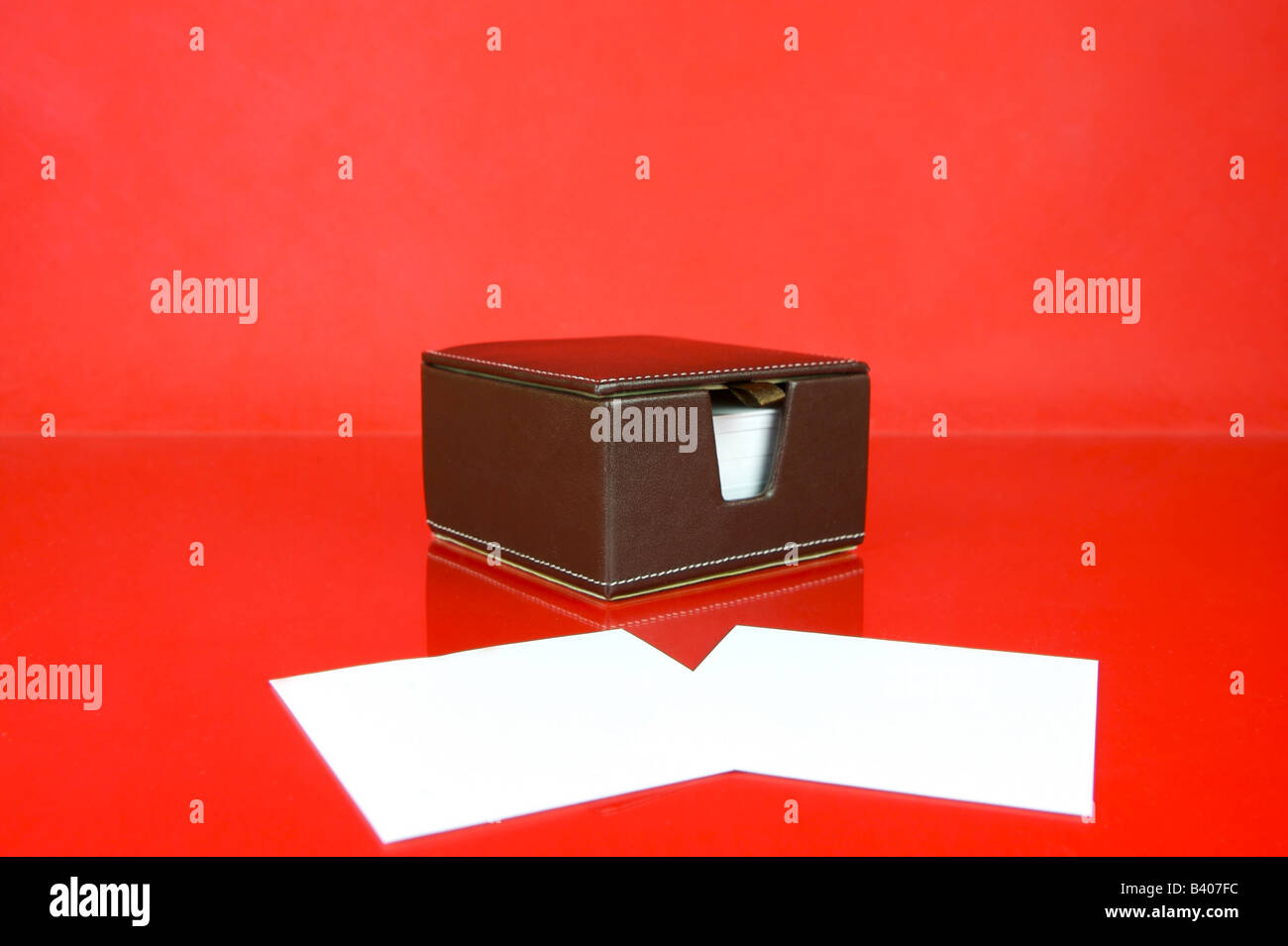 A note block isolated against a red background Stock Photo - Alamy