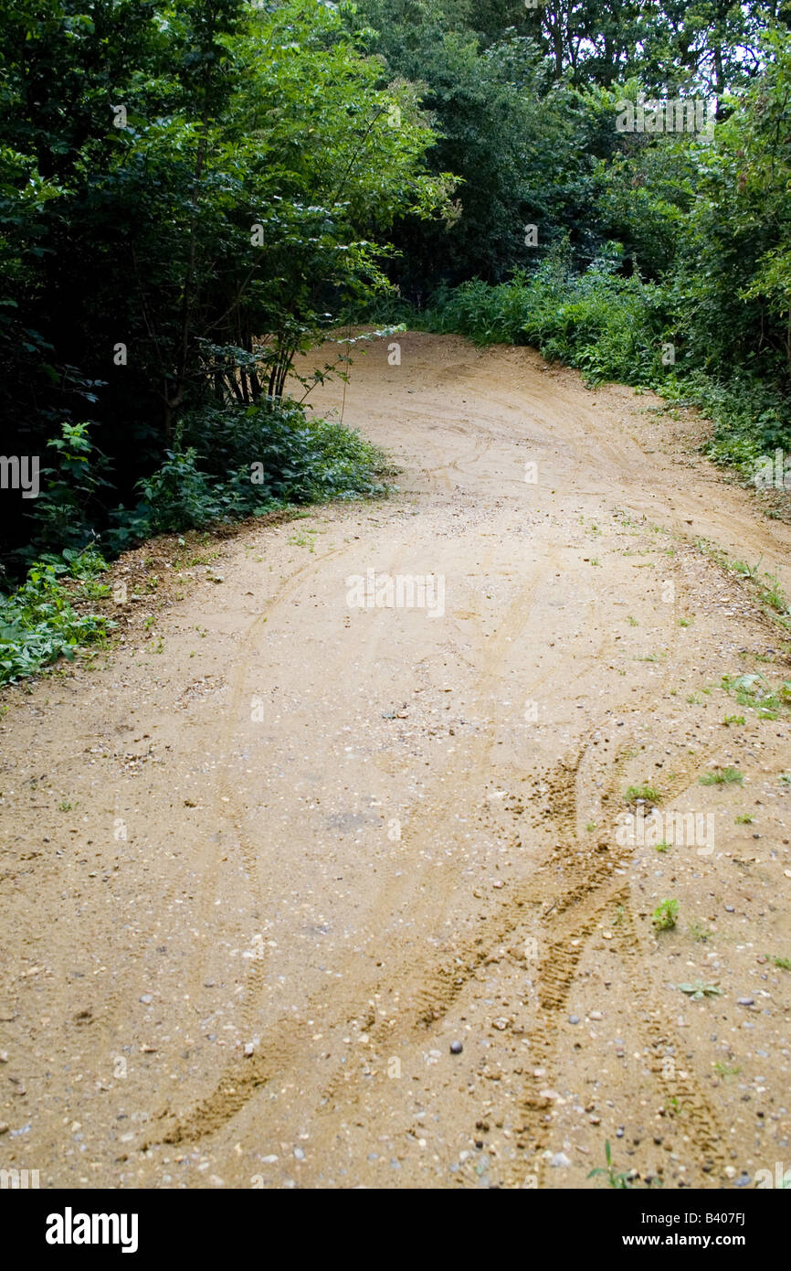A sand BMX track disapears into the forest Stock Photo - Alamy