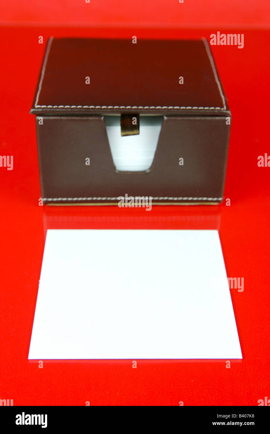 A note block isolated against a red background Stock Photo - Alamy