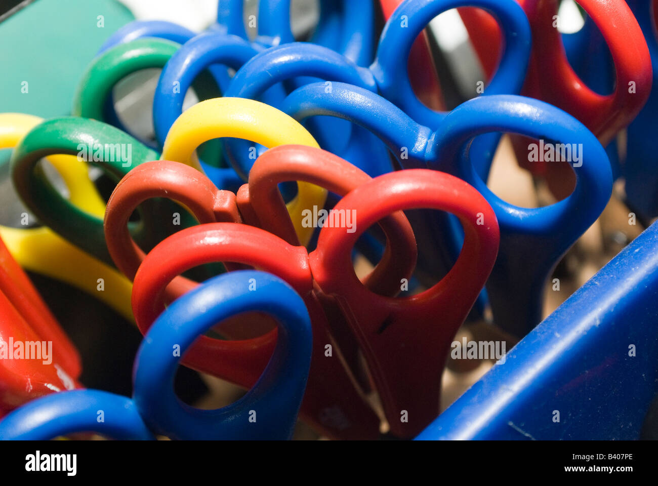colourful handles of pairs of scissors in a school classroom in the uk ...