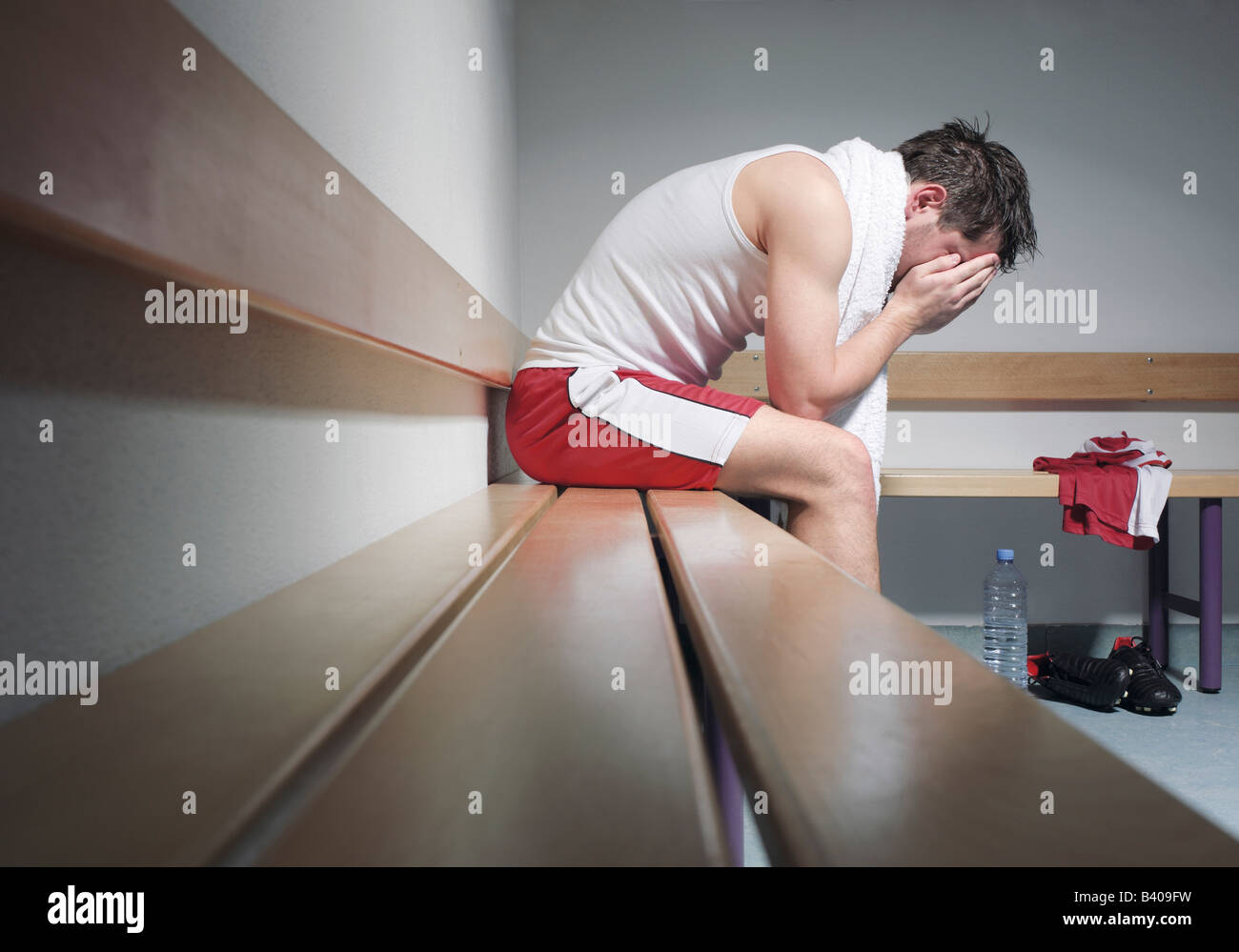 Exhausted soccer player sitting in changing room Stock Photo - Alamy
