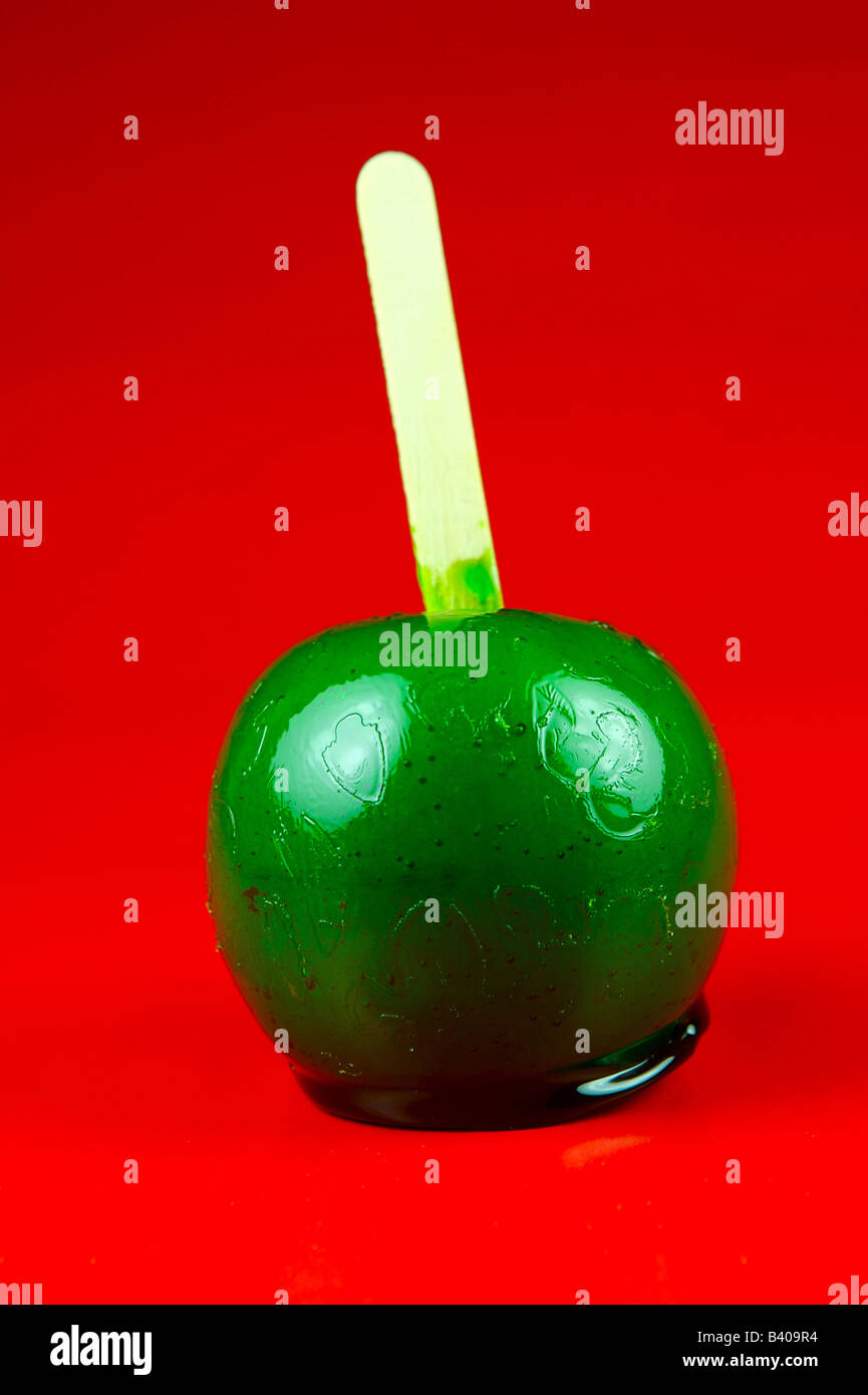 Toffee apples isolated against a red background Stock Photo - Alamy